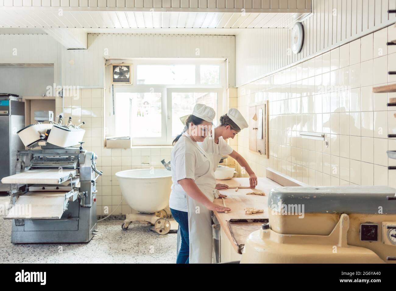 Wide view of bread production in bakery with two women working Stock ...