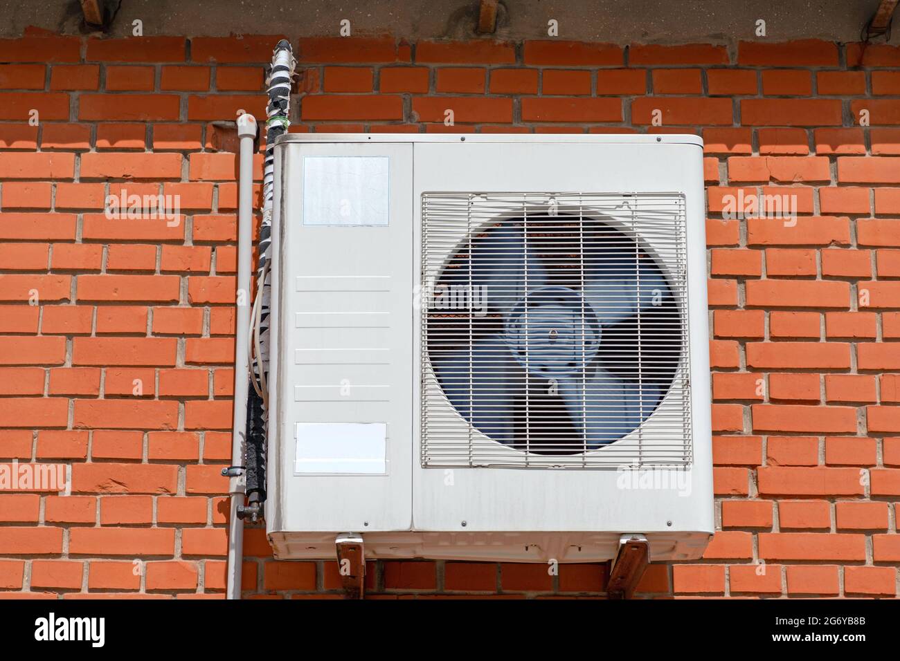 Exterior Unit Air Conditioner at Brick Wall House Stock Photo - Alamy