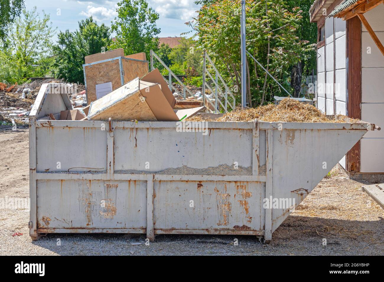Overflow of Trash Skip Dumpster Container at Sunny Day Stock Photo - Alamy