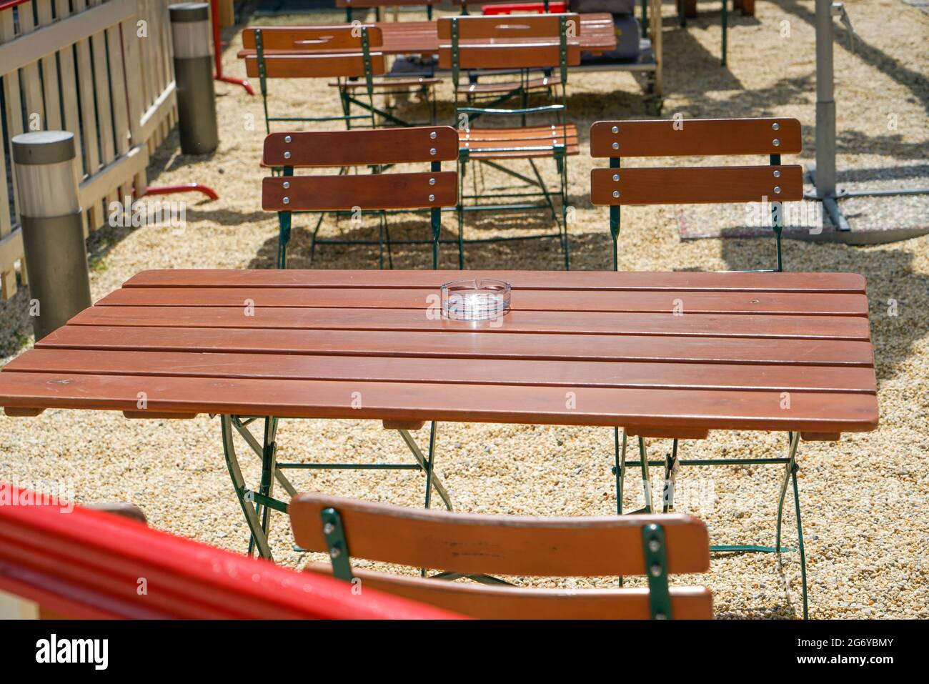 Benches and chairs at tables invite you to relax and unwind Stock Photo ...