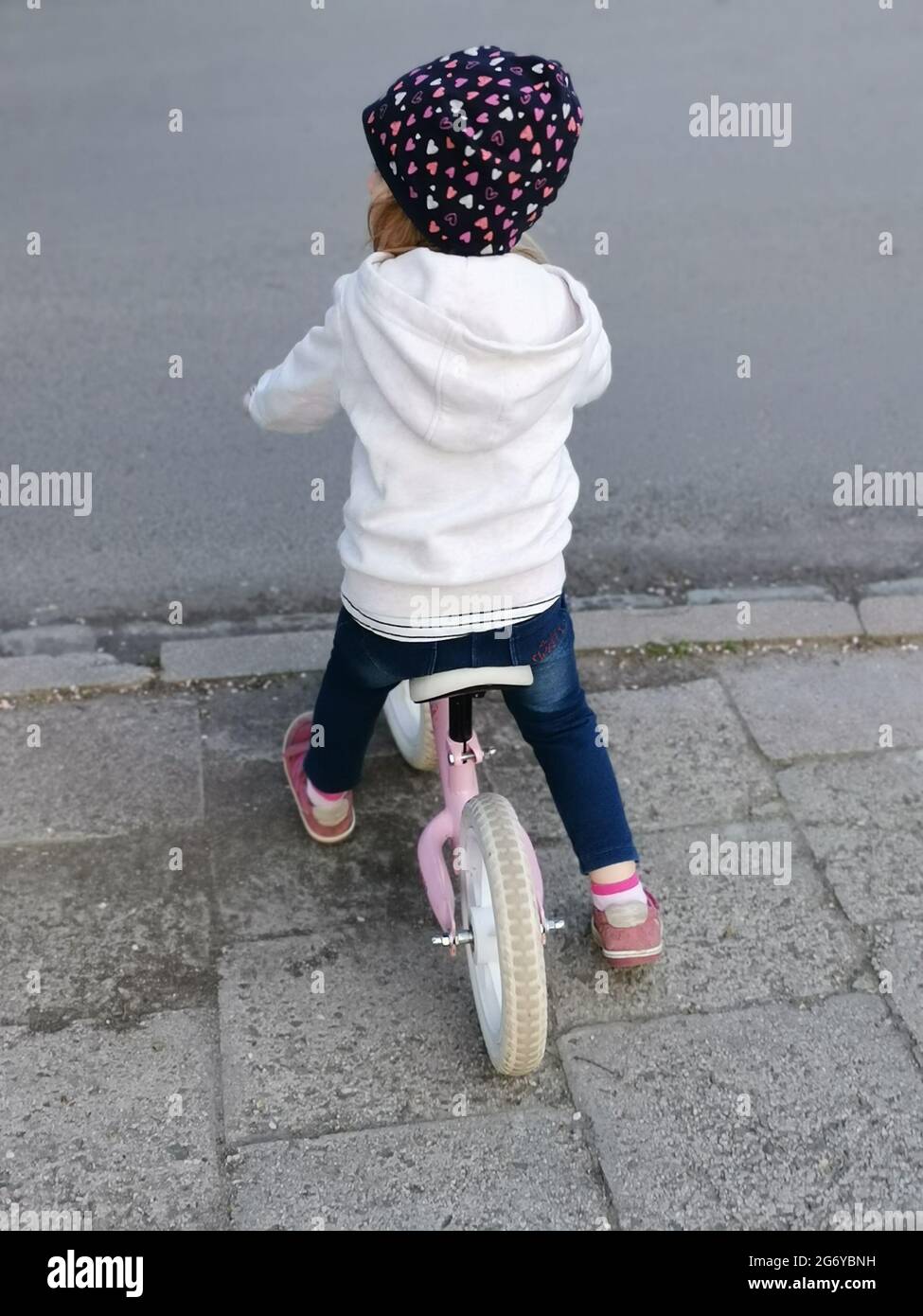 Vertical shot of a child on a bike outdoors Stock Photo - Alamy