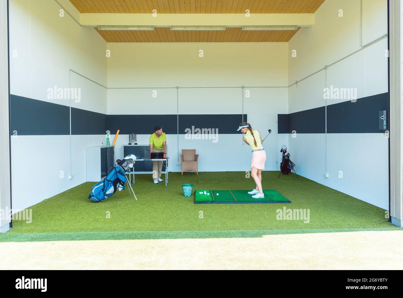 Full length view of a dedicated golf coach using modern equipment ...