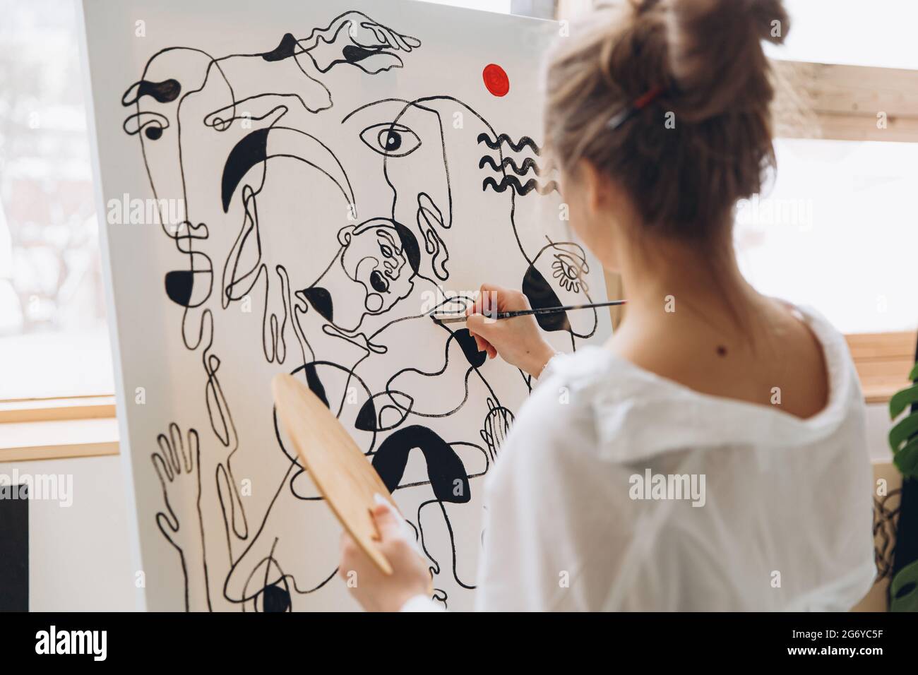 Back view of female artist painting on canvas at studio Stock Photo - Alamy