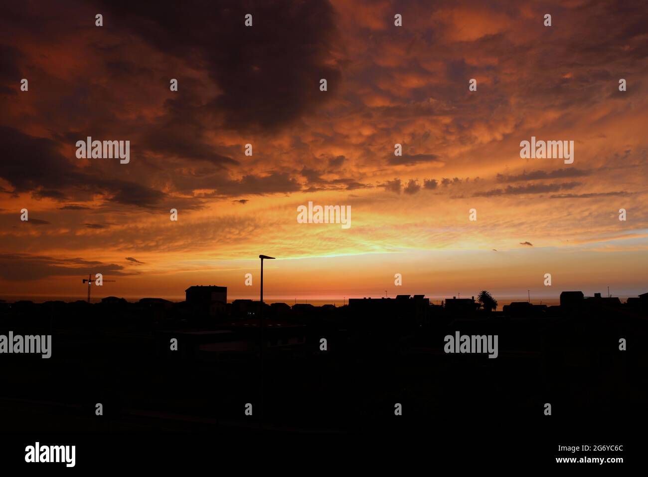 Sunset with extreme colours and urban silhouette Stock Photo - Alamy