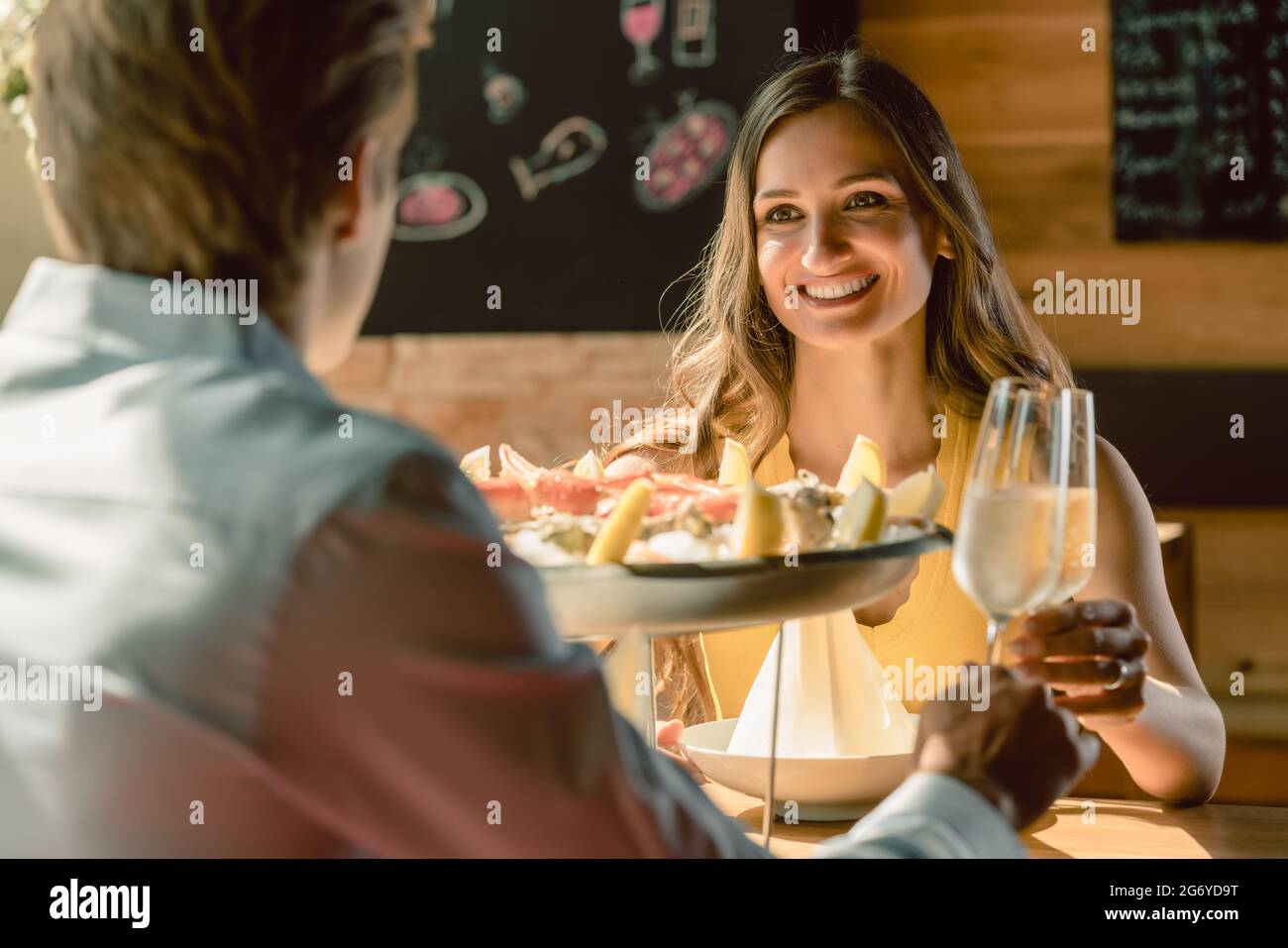 Happy young couple in love toasting with champagne during romantic ...