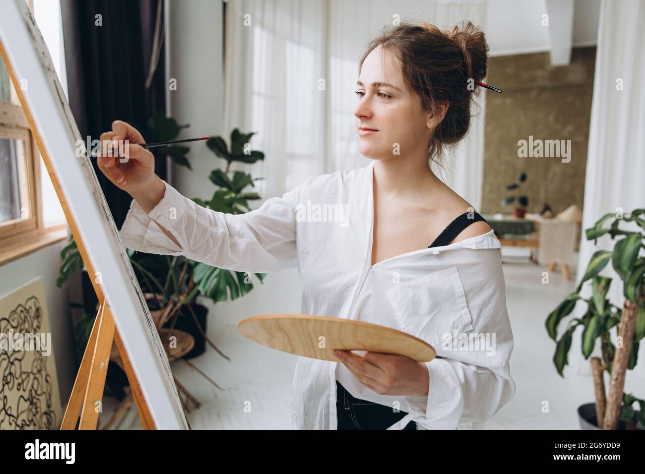 Creative person using brush and color palette for drawing Stock Photo ...