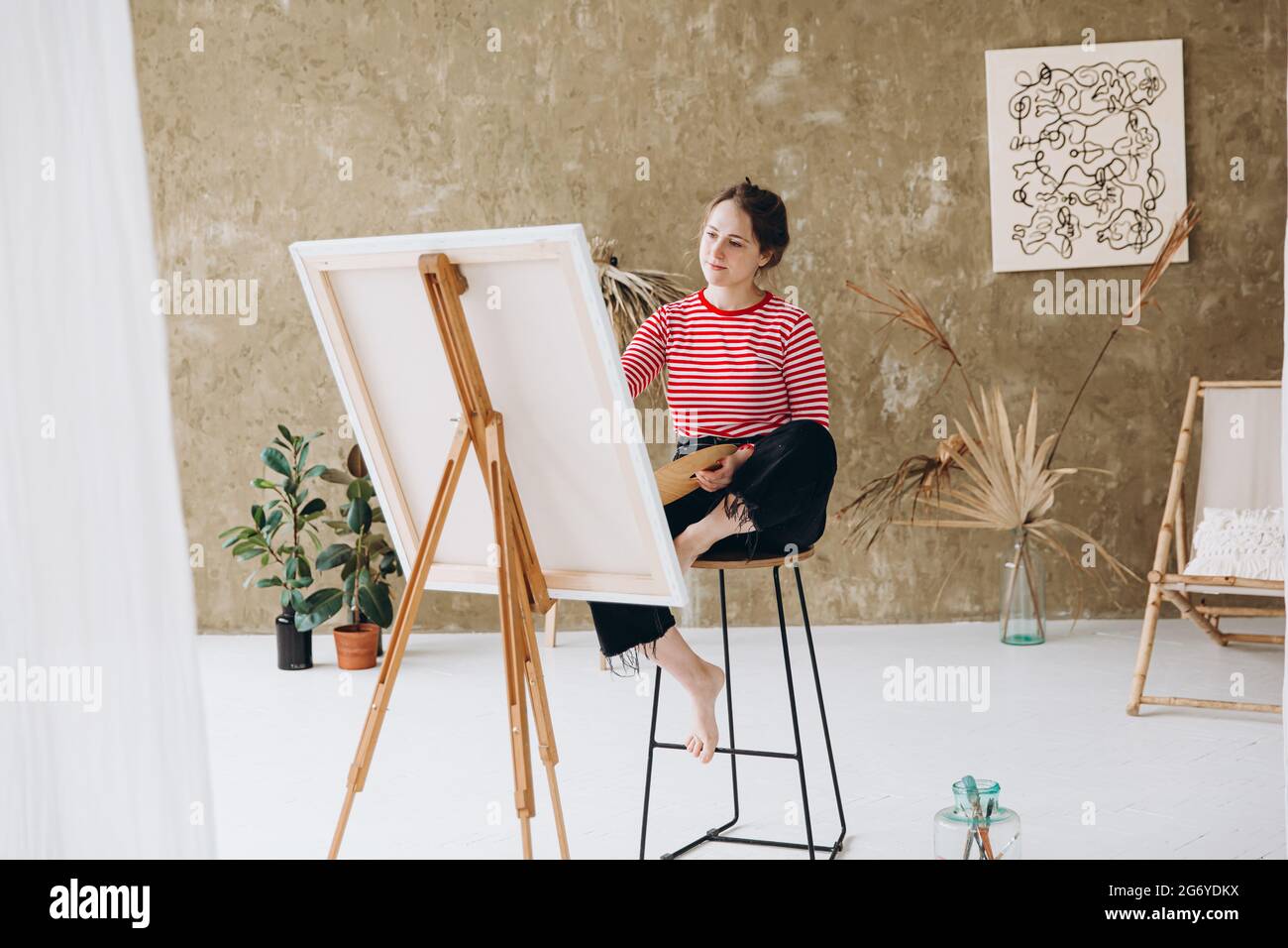 Beautiful woman using brush and color palette for painting Stock Photo ...