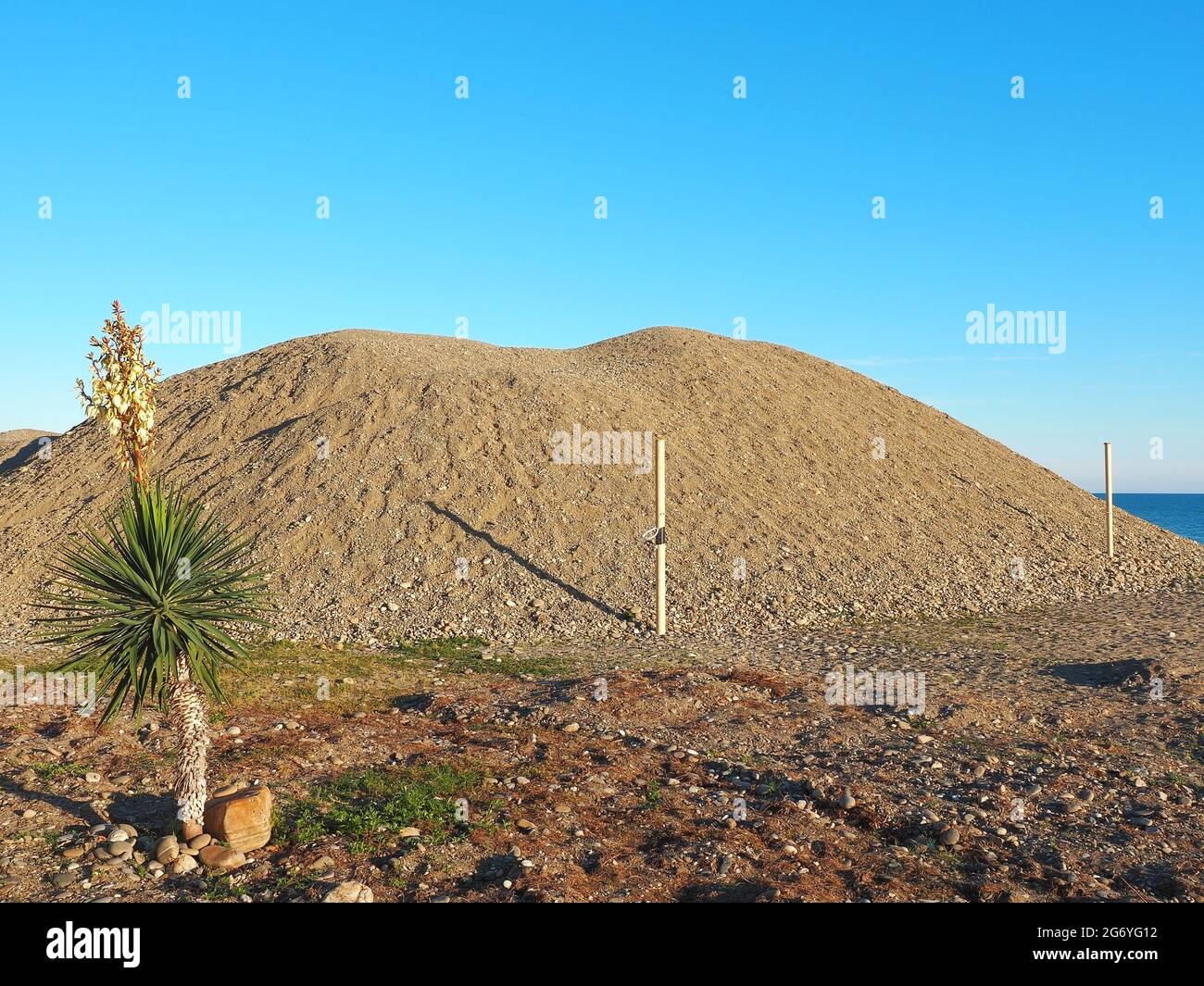Mound of small pebbles and sand on the southern seaside area under a ...