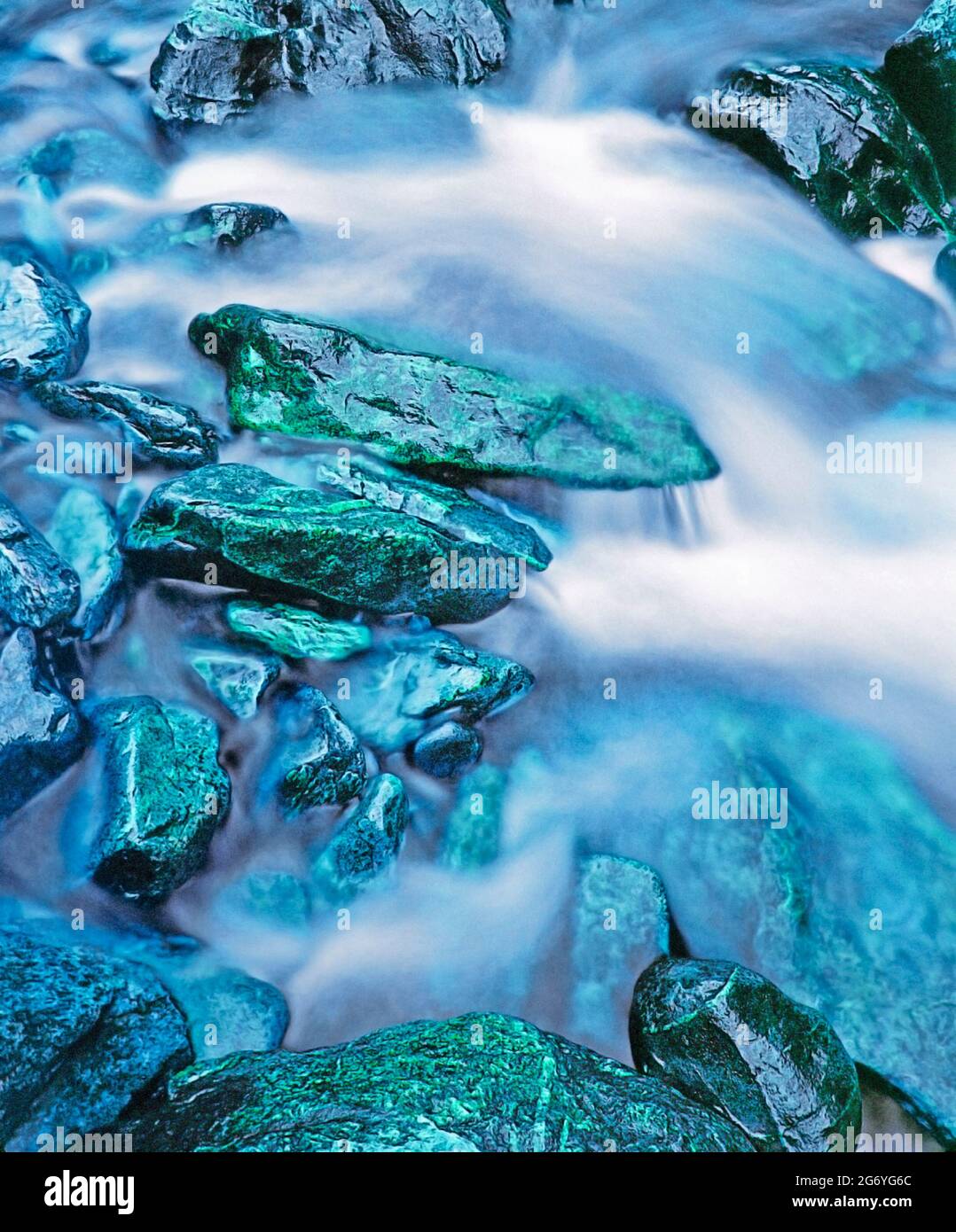 green coloured rocks, and cascade Stock Photo - Alamy