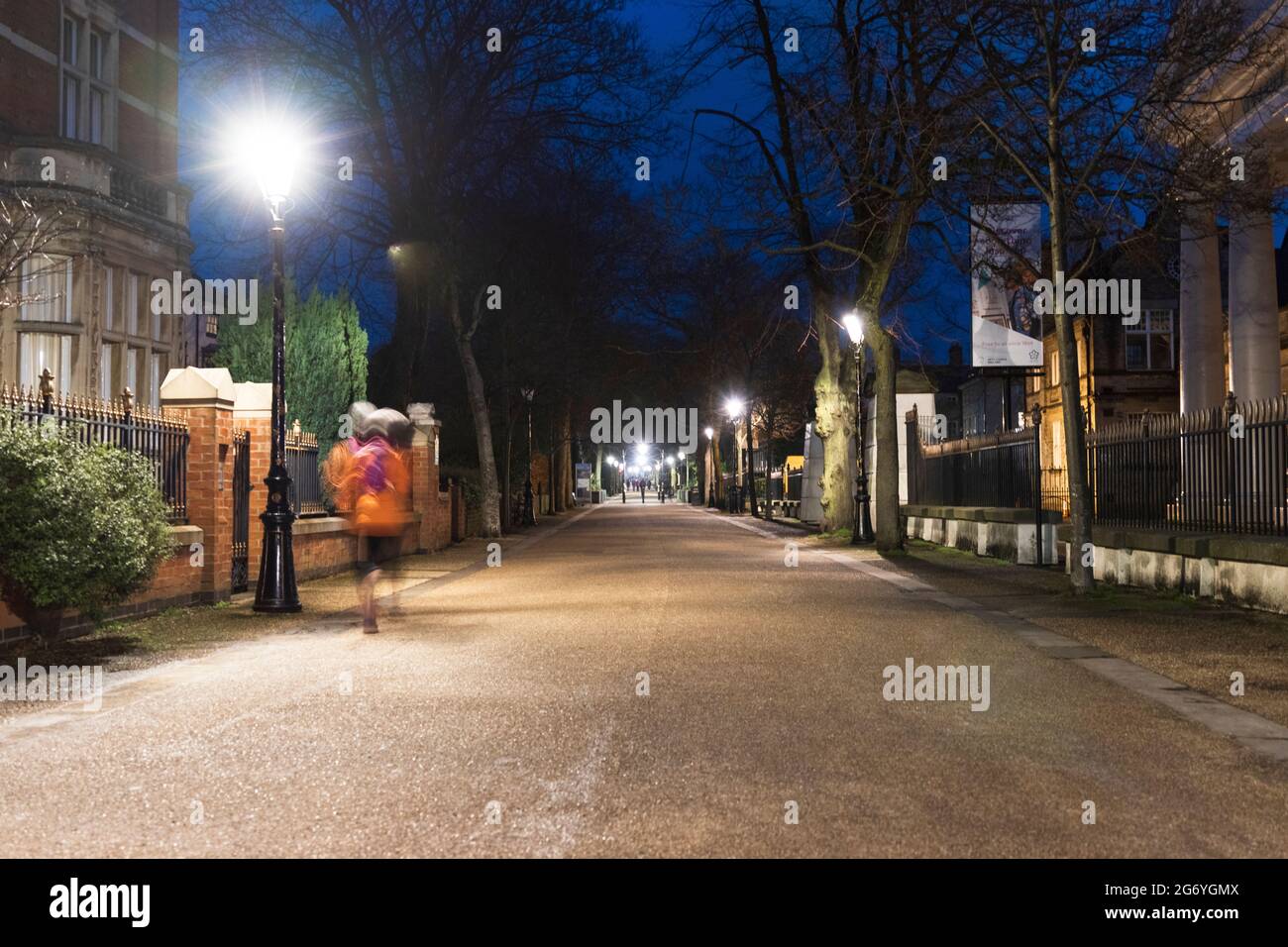 Outside New Walk Museum at night, shows woman running on the left with ...