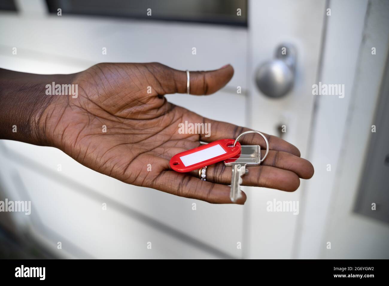 African Hand With Key At Home Entrance Stock Photo - Alamy