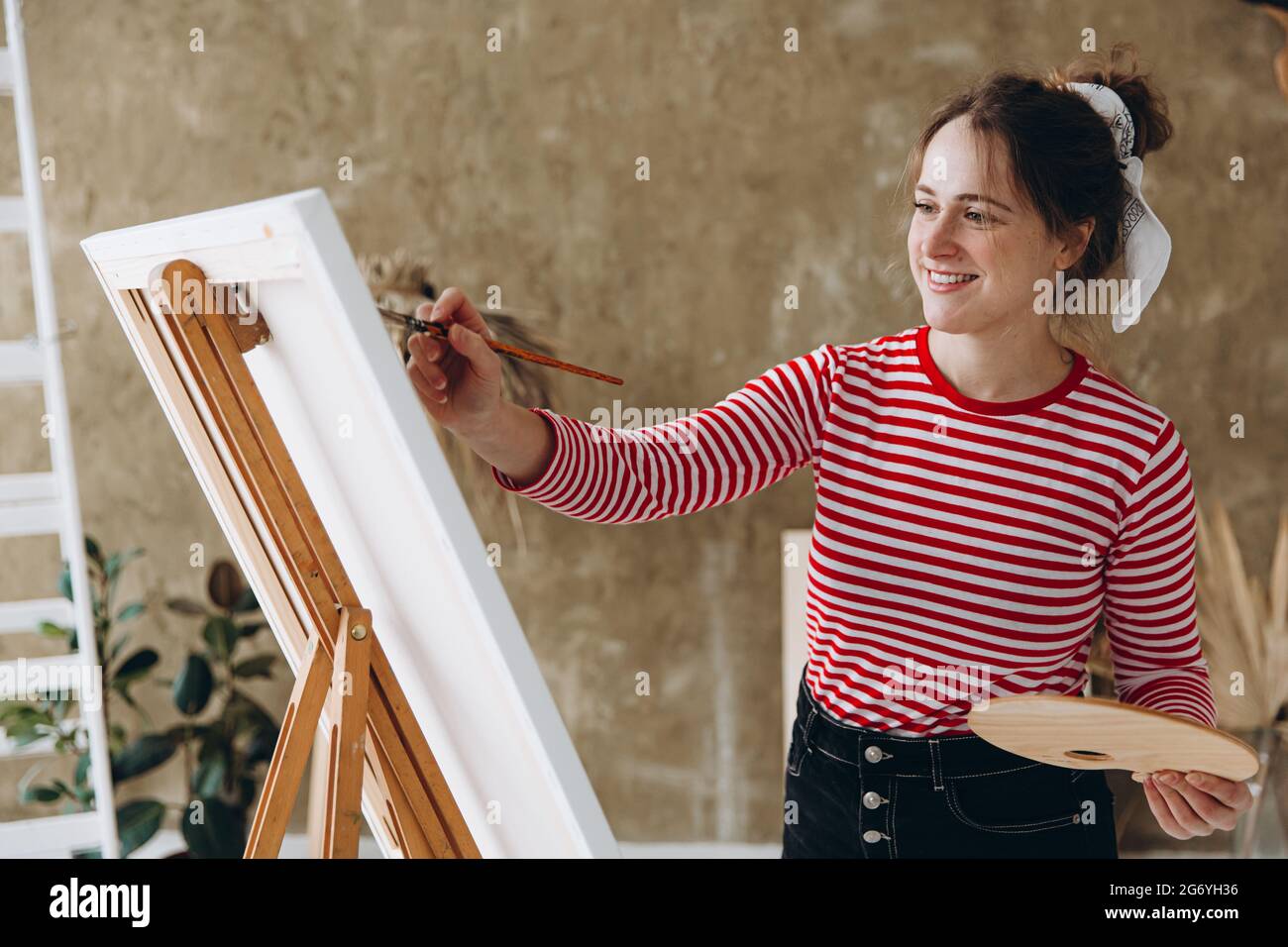 Smiling artist using brush and color palette for drawing Stock Photo ...