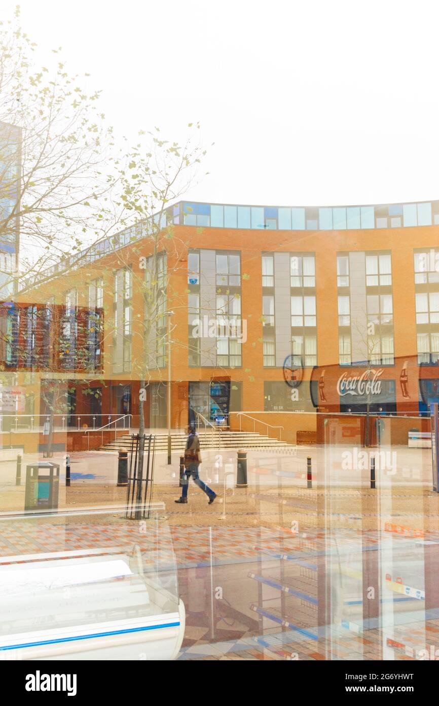 New Walk Place piazza, shows a man walking across a road speaking on ...