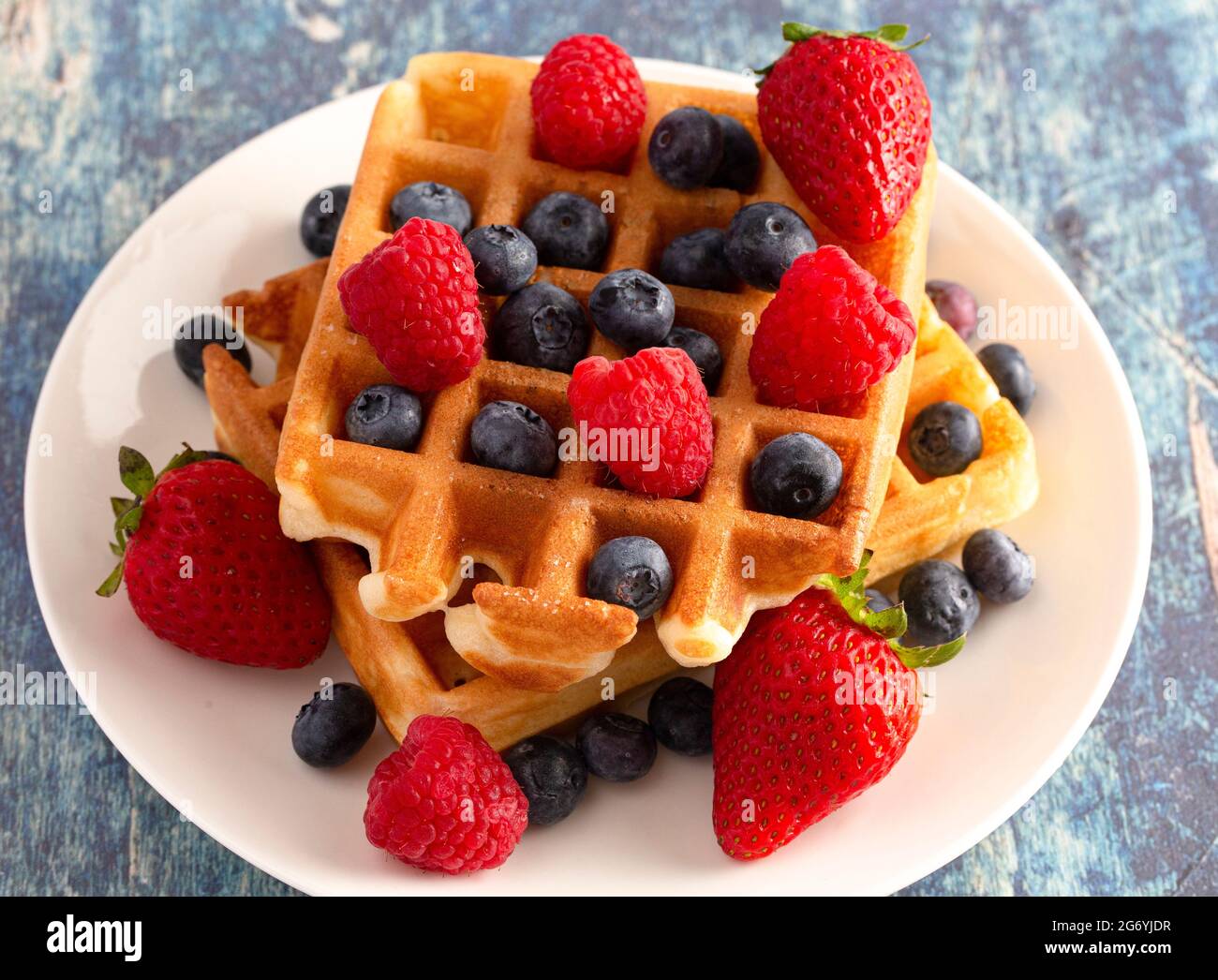 Classic Berry Waffles on a Rustic Blue Wood Table Stock Photo - Alamy