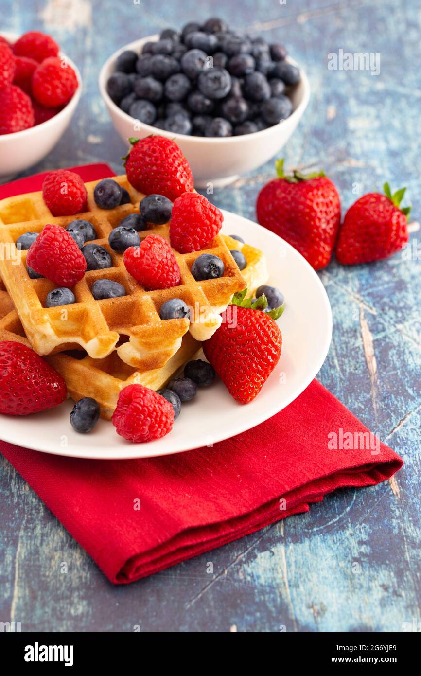 Classic Berry Waffles on a Rustic Blue Wood Table Stock Photo - Alamy