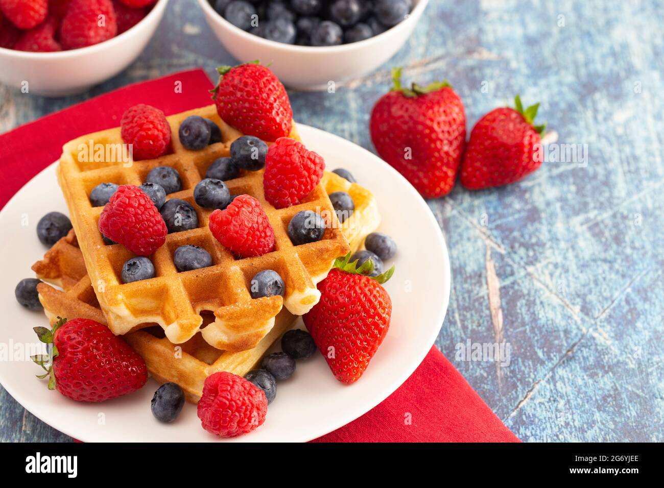 Classic Berry Waffles on a Rustic Blue Wood Table Stock Photo - Alamy