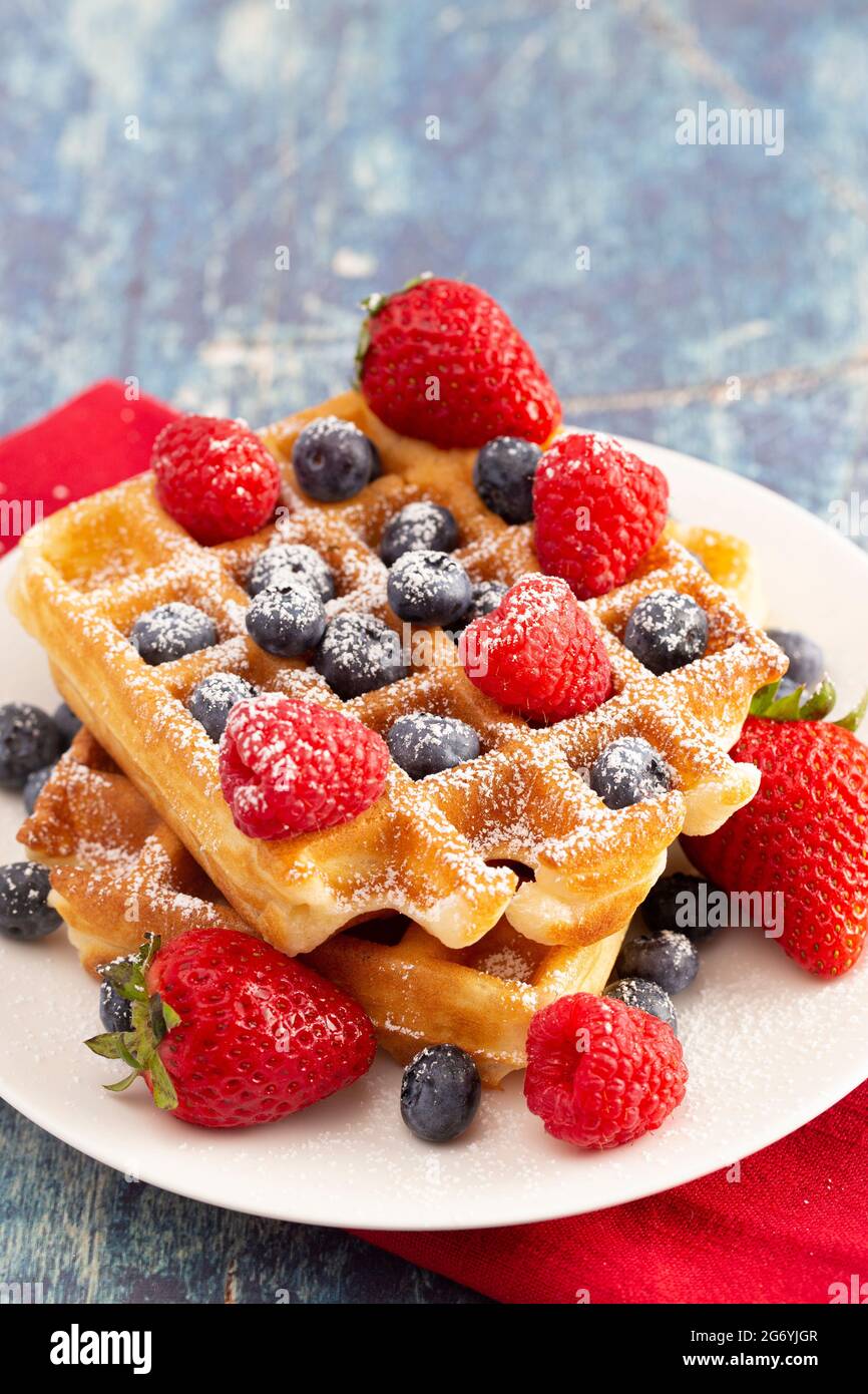 Classic Berry Waffles on a Rustic Blue Wood Table Stock Photo - Alamy