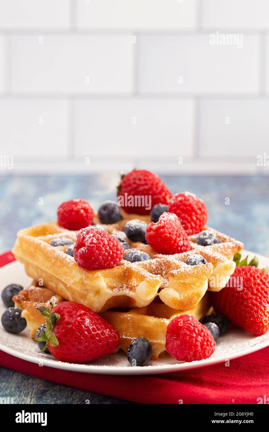 Classic Berry Waffles on a Rustic Blue Wood Table Stock Photo - Alamy