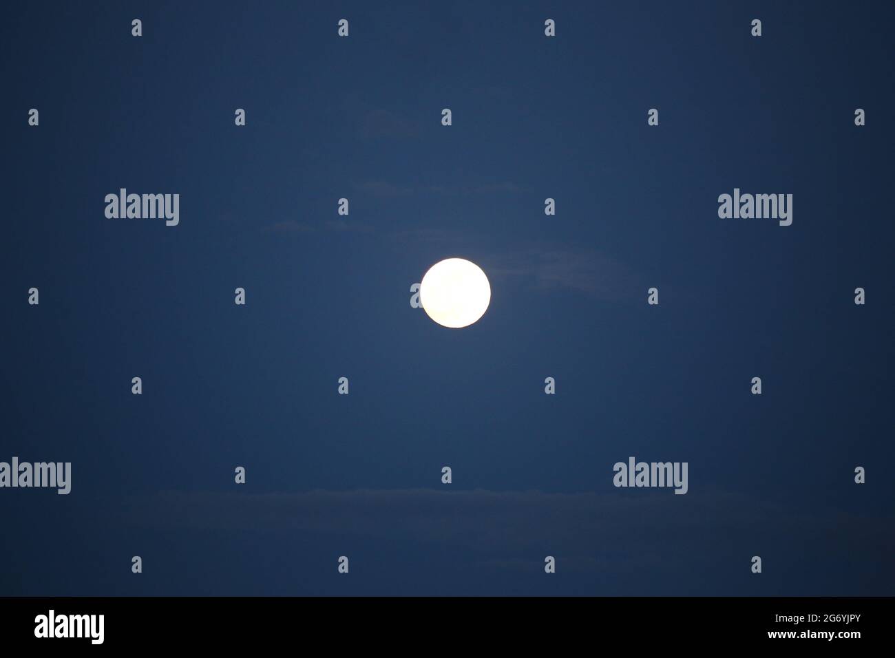 Glowing full moon up in the cloudy sky Stock Photo - Alamy