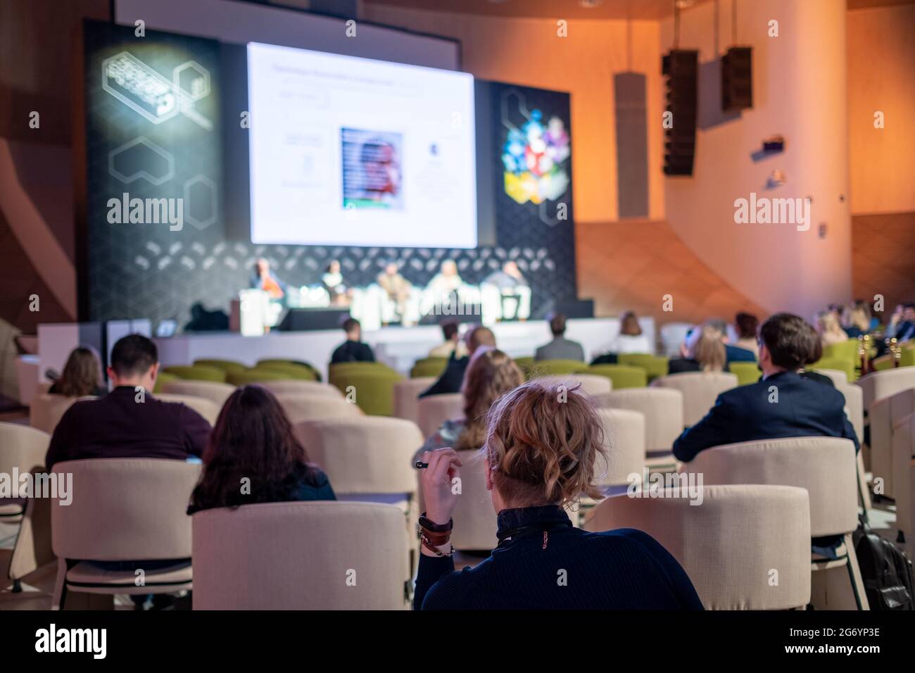 Business conference participants sitting in auditorium Stock Photo - Alamy