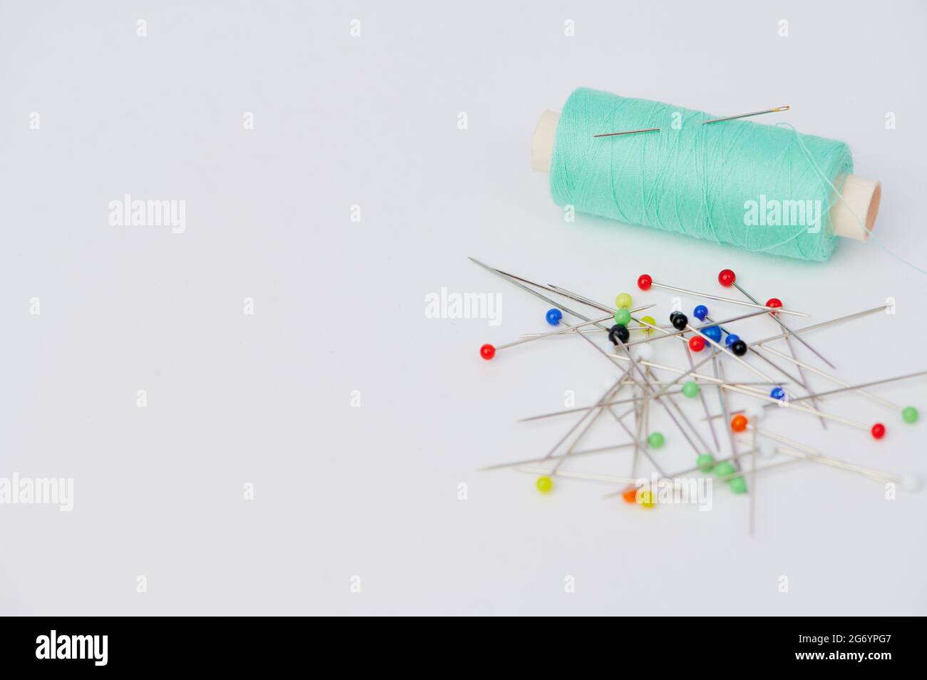 sewing thread and pins on white background with copy space Stock Photo ...