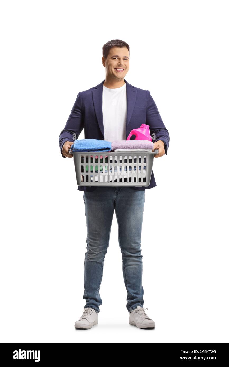 Full length portrait of a young man carrying a laundry basket with ...