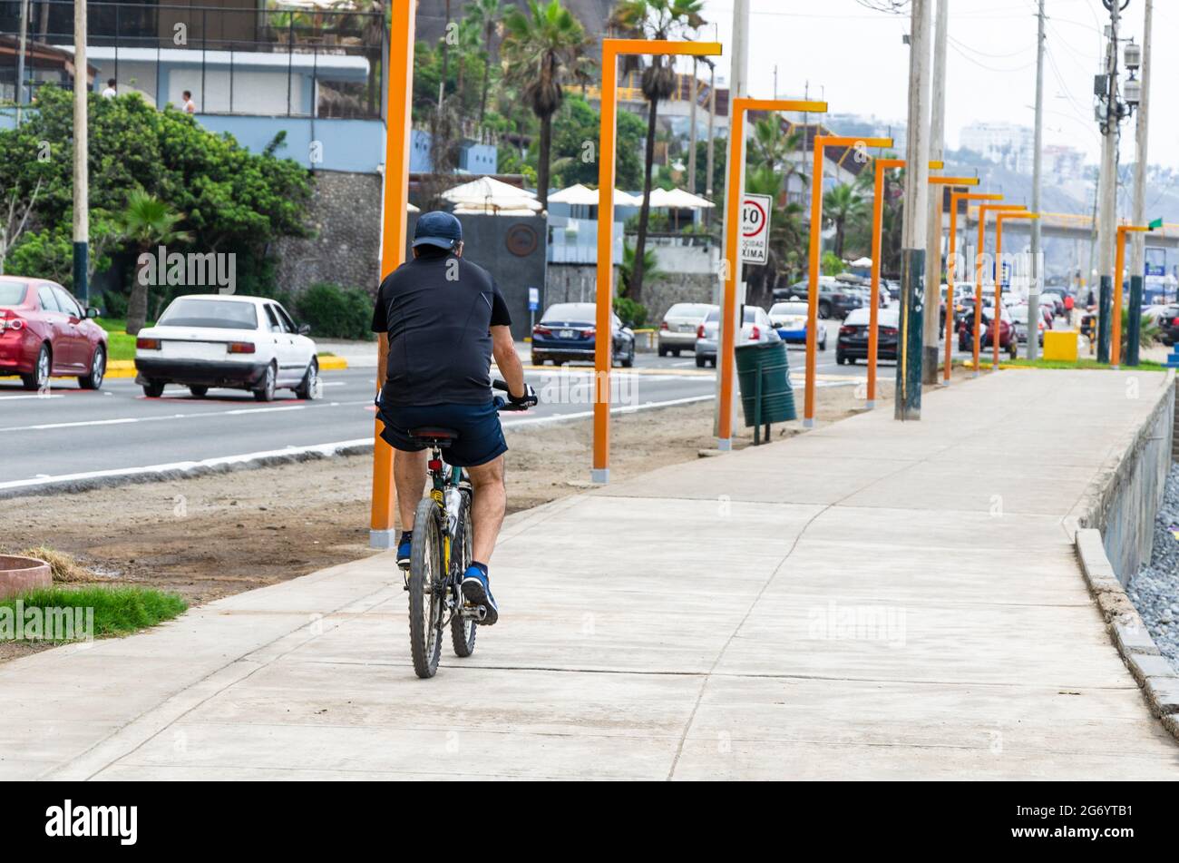 A cyclist riding his bike on the sidewalk, concept of sport life ...