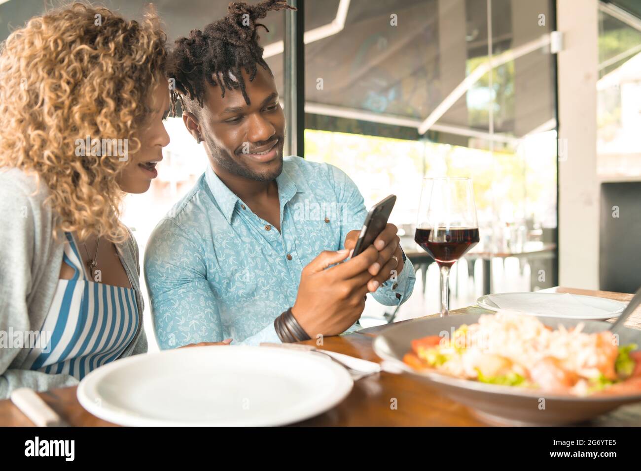 African couple flirting mobile phone hi-res stock photography and ...