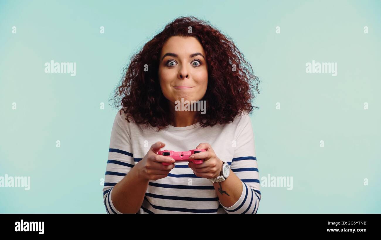 KYIV, UKRAINE - JUNE 30, 2021: young tensed woman holding pink joystick ...