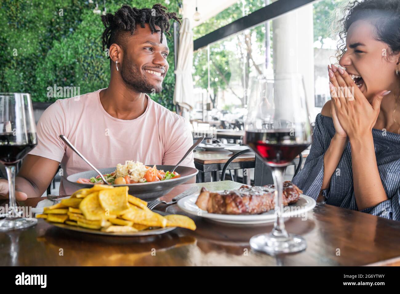 Couple having lunch together at a restaurant Stock Photo - Alamy