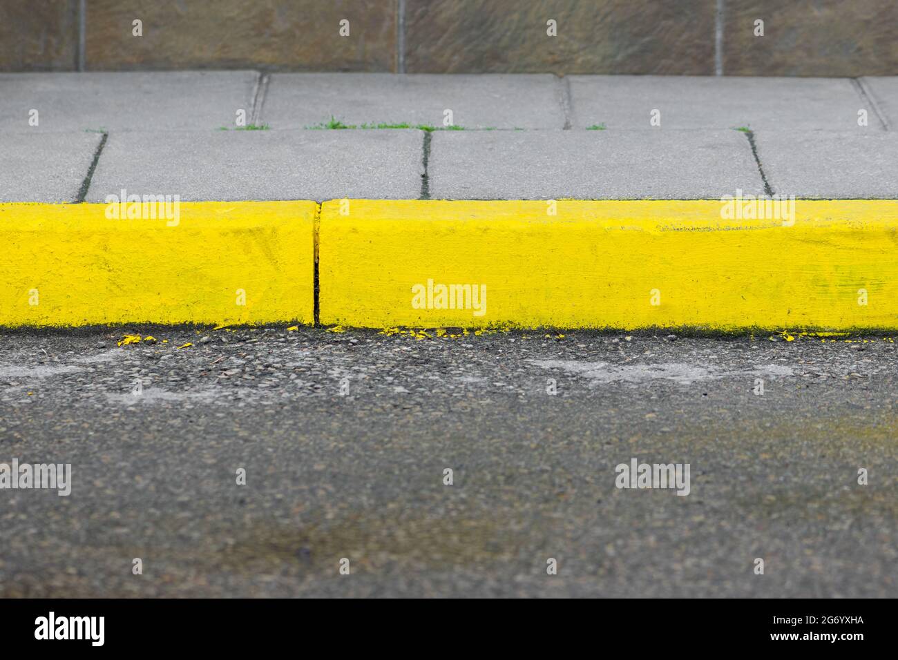 Sidewalk painted with yellow paints and concrete path with road ...