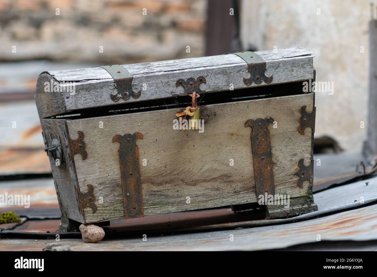 Very old wooden chest with rusty metallic decorations and lock with ...