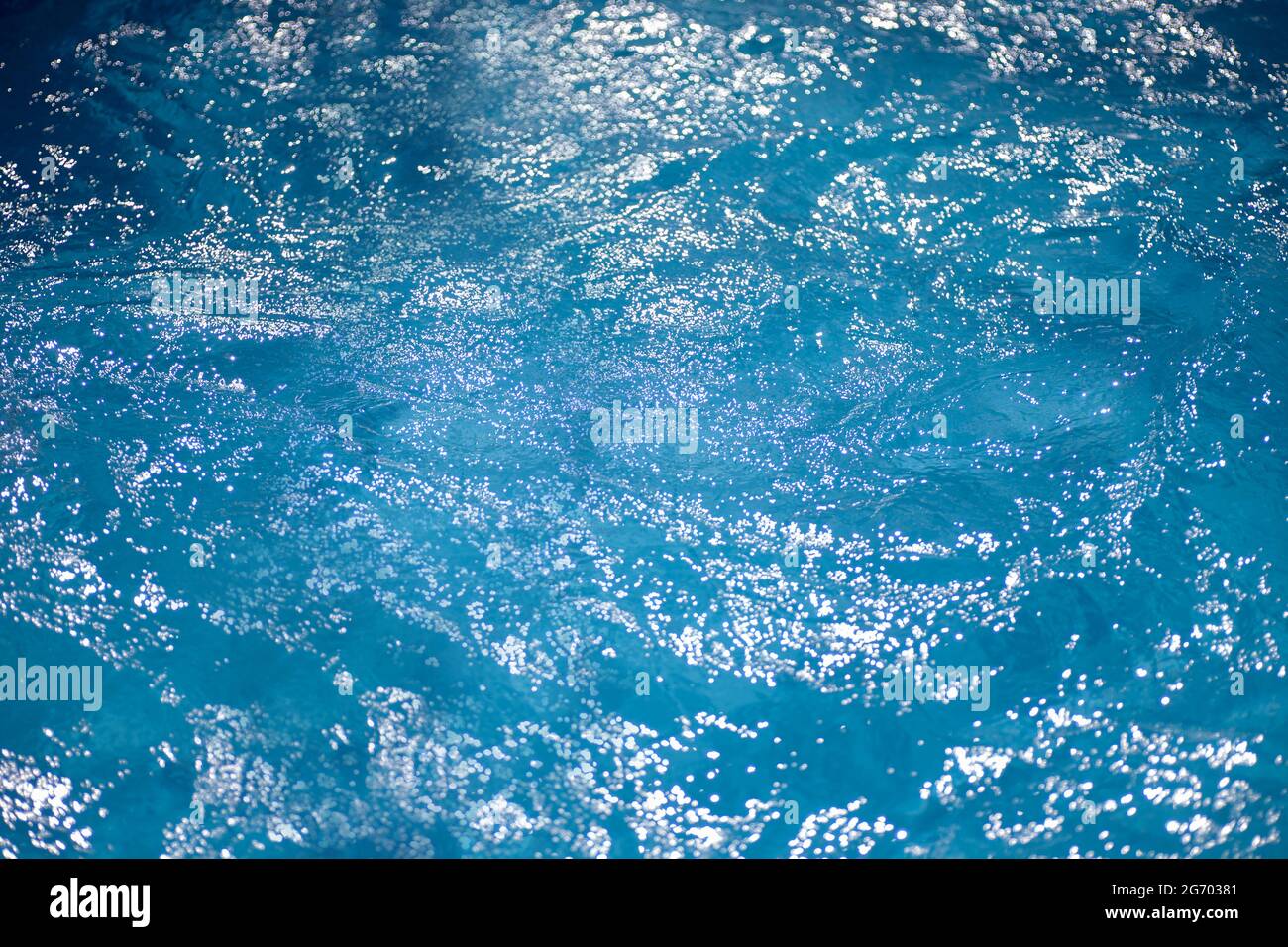 sparkling water surface in the pool in the sun, summer minimalistic ...