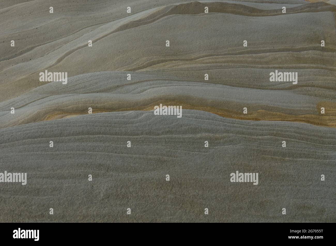 Wavy patterned natural sandstone gives the impression of an abstract ...