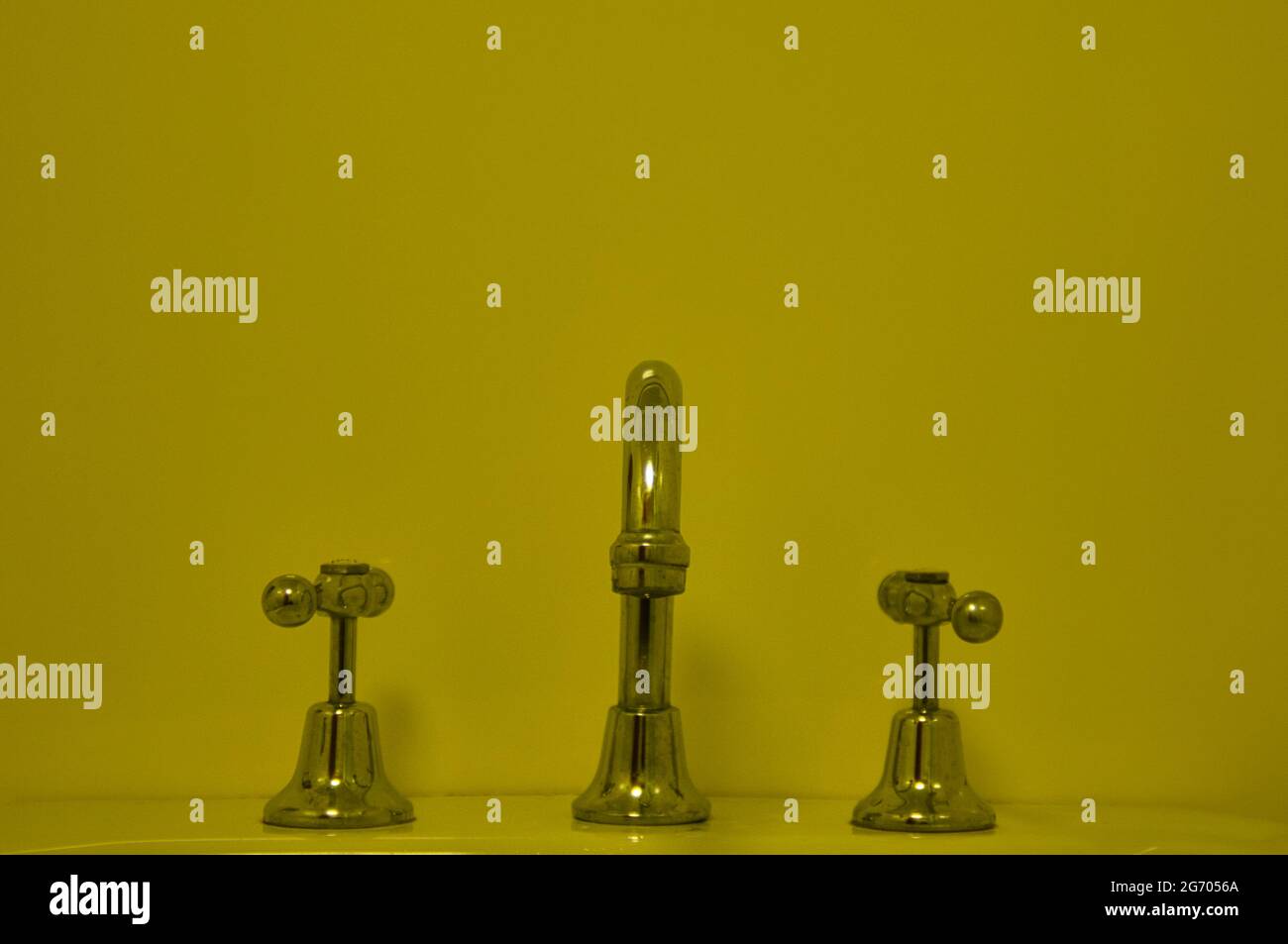 Shiny vintage faucet with smooth yellow-green background Shiny vintage ...