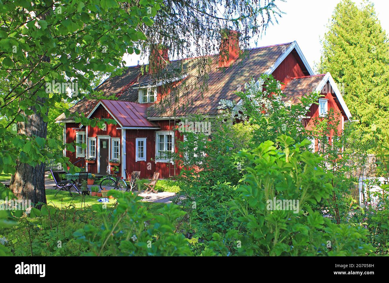 Red country house with garden Stock Photo - Alamy
