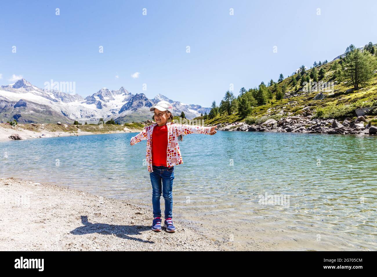 funny little happy girl on the mountain top. children outdoors ...