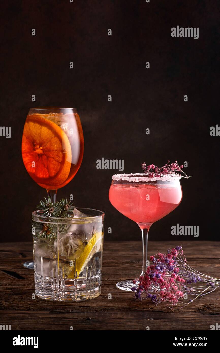 different beautiful cocktails in warm colors on a dark background Stock ...