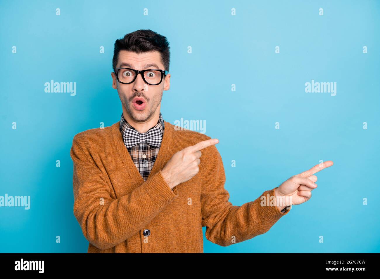 Portrait of impressed guy open mouth speechless direct fingers empty ...