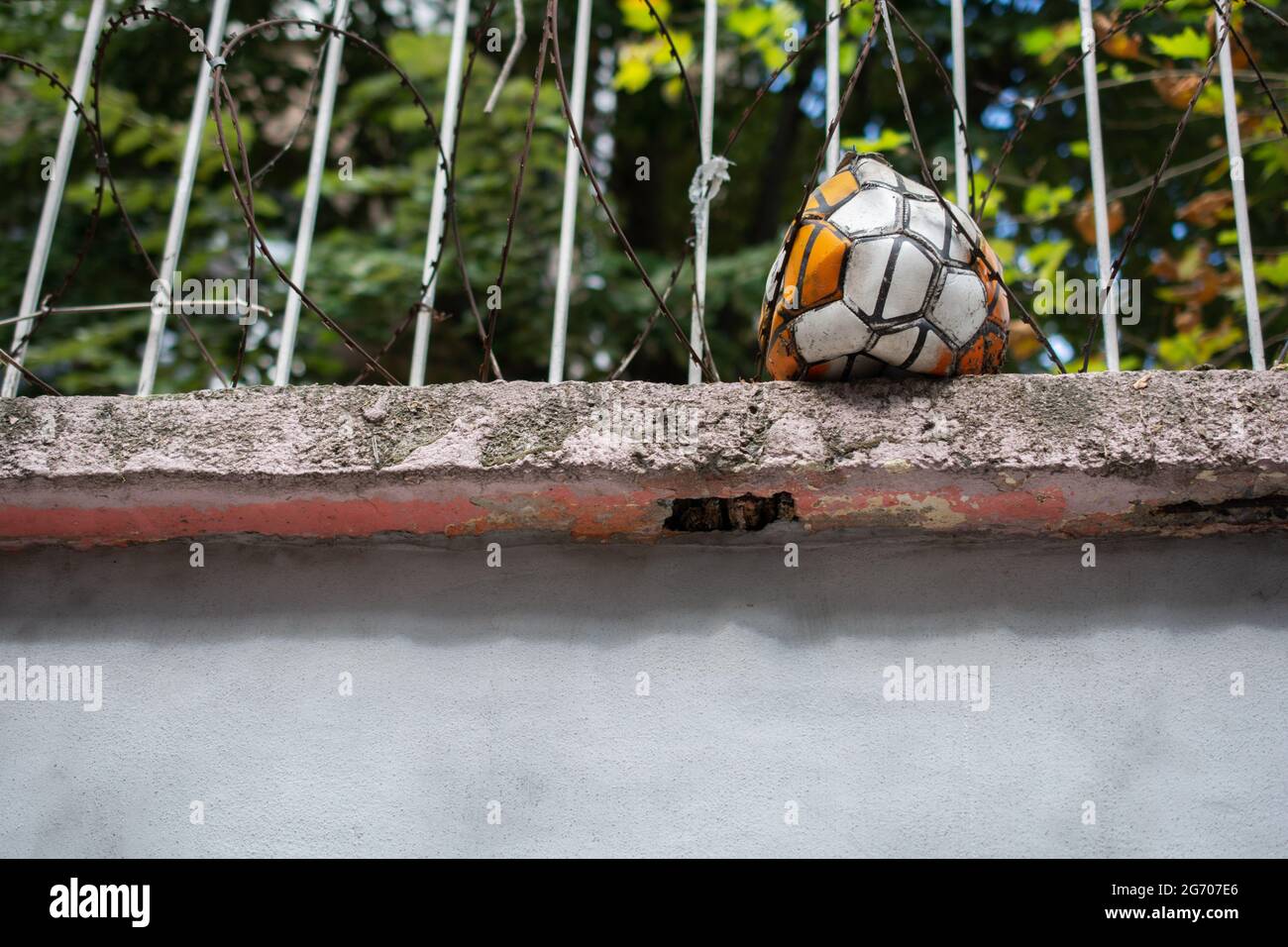 Low angle shot of an inflated ball stuck in the railing Stock Photo - Alamy