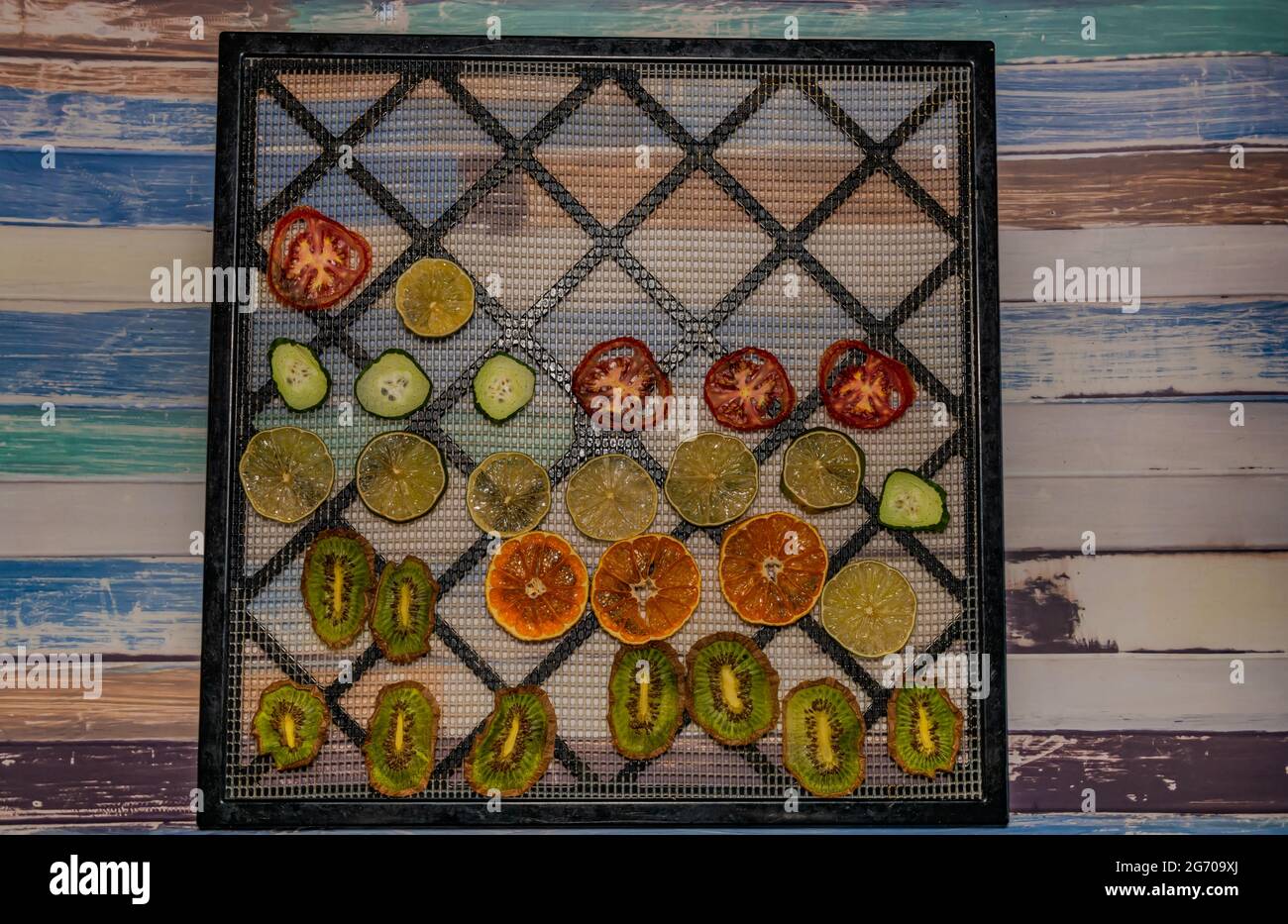 Dry color fruit and vegetable on color wooden table and black drying ...