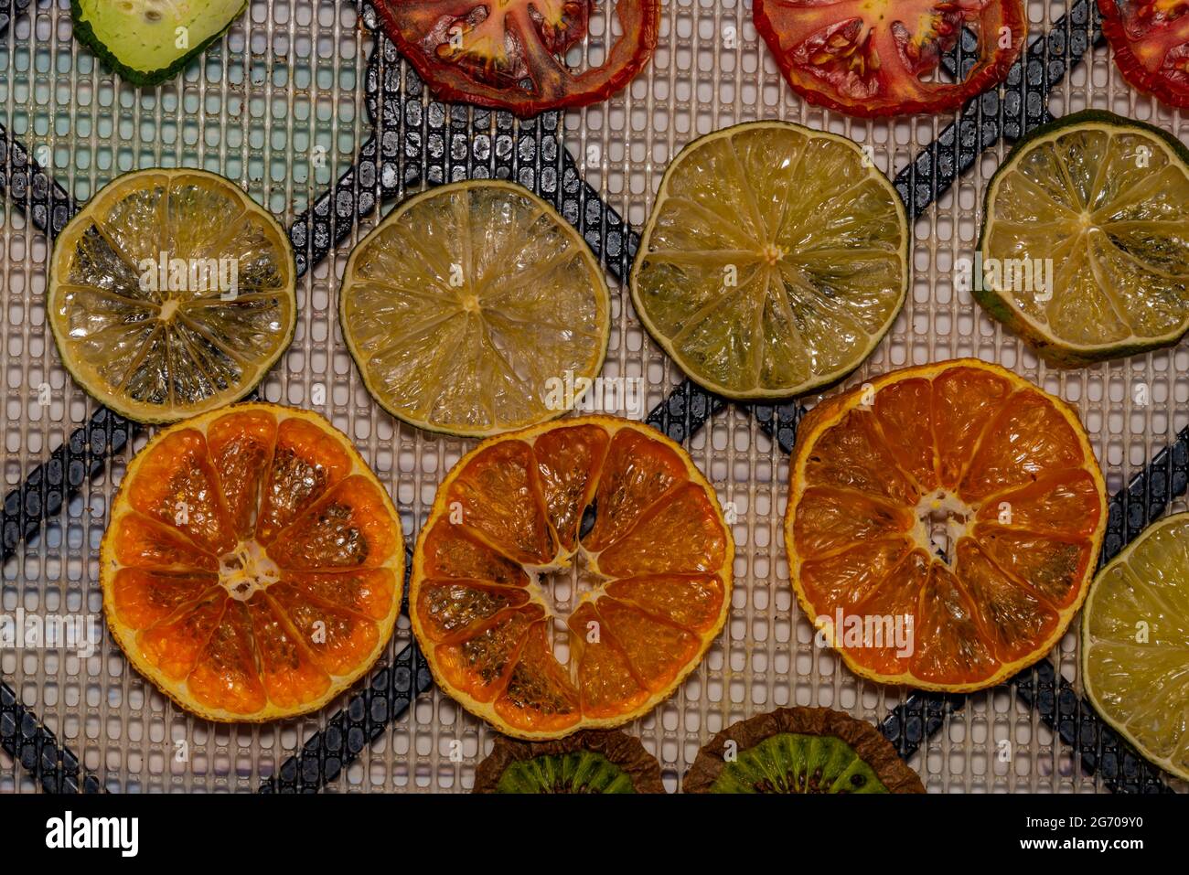 Dry color fruit and vegetable on color wooden table and black drying ...