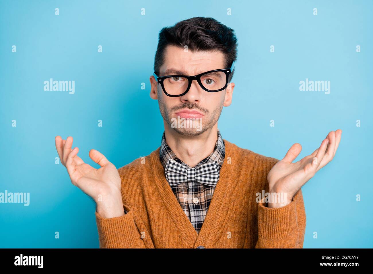 Photo of young man unsure uncertain puzzled problem no answer clueless ...