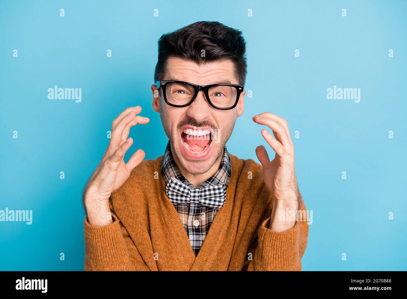 Photo of angry furious young man raise hands scream yell loud isolated ...