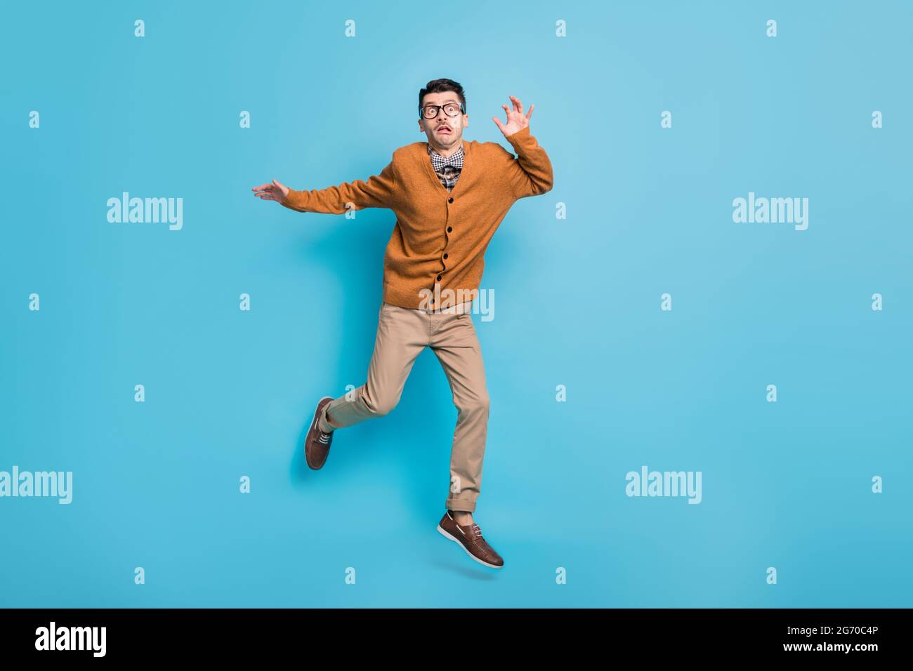 Full body photo of scared young man jump up air afraid wear glasses ...