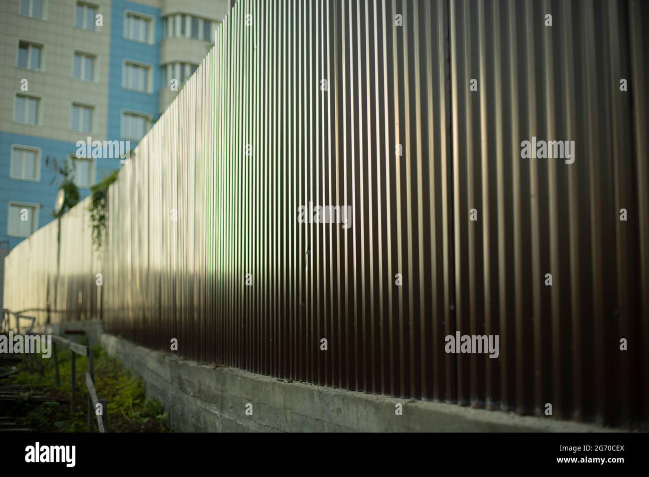 Steel fence. The fence is high on the street. Solid barrier Stock Photo ...