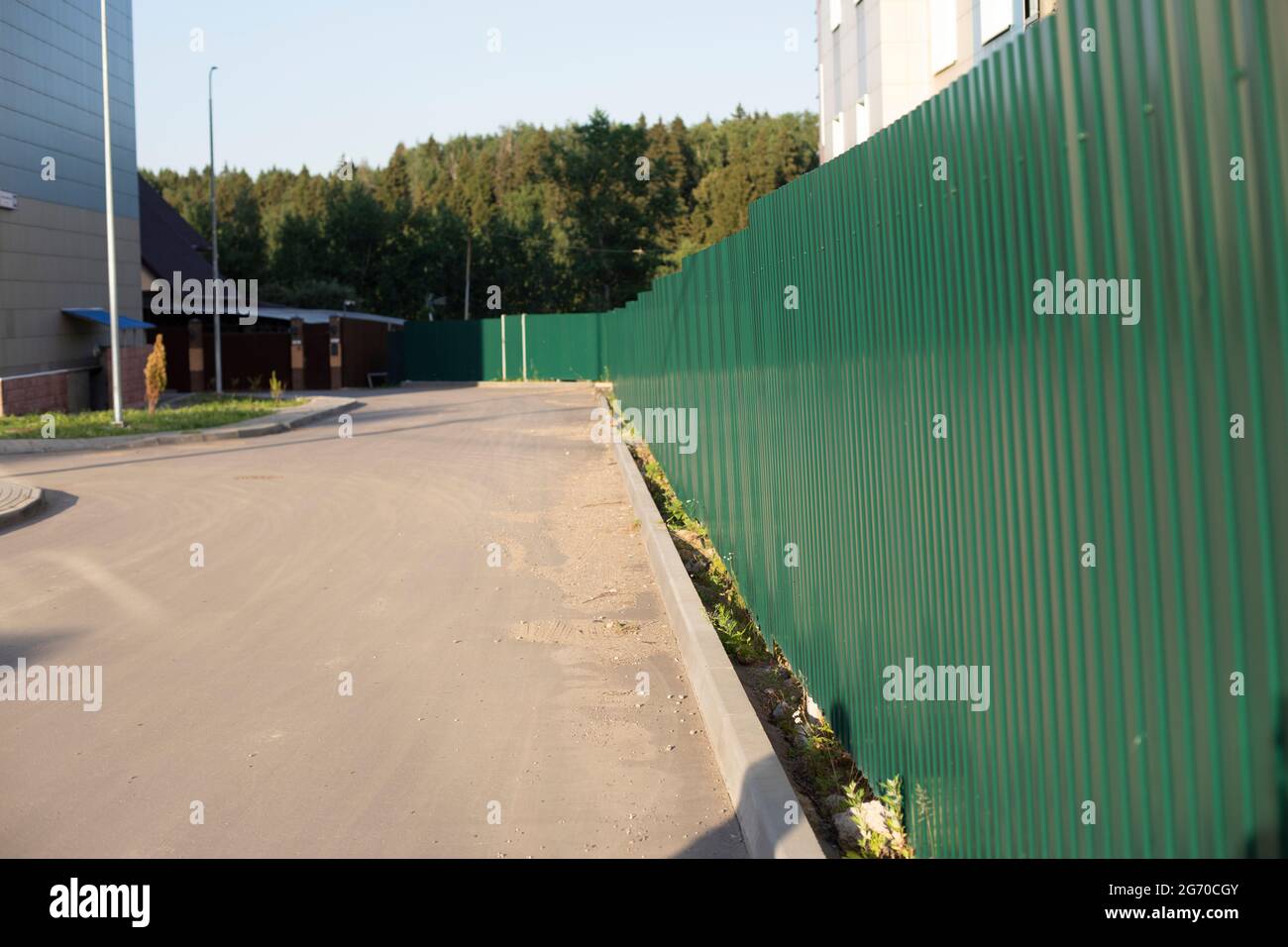 Steel fence. The fence is high on the street. Solid barrier Stock Photo ...