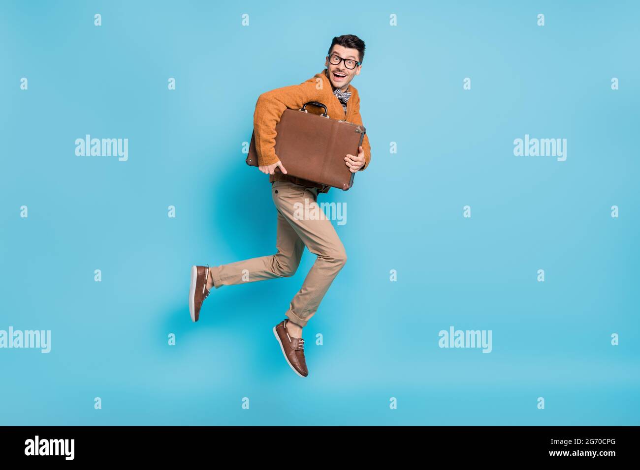 Full size profile side photo of young excited man go walk run jump ...