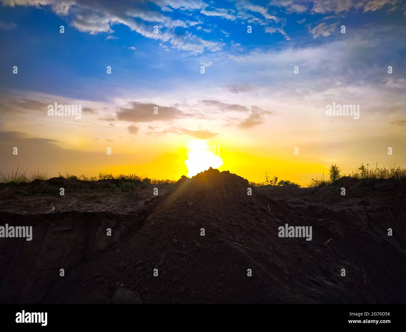 Beautiful landscape of a soil mound in a sunset sky background Stock ...