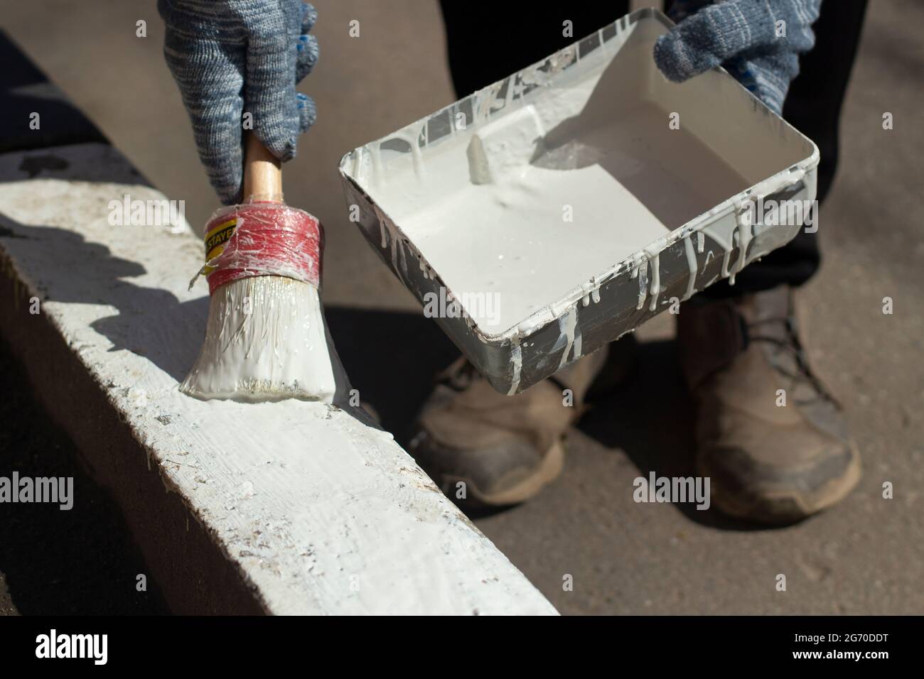 Paint for the street. Painting the object. Marking the road. Work with ...